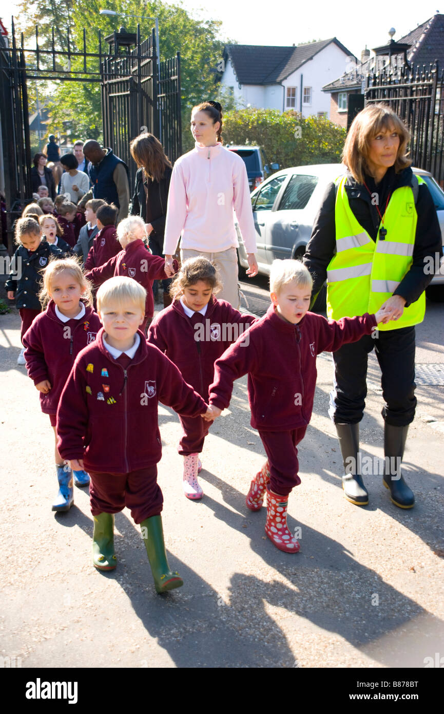 Junior school children on supervised walk with teachers Stock Photo - Alamy