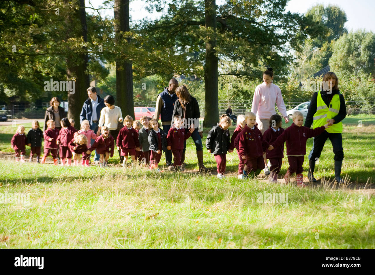 Junior school children on supervised walk with teachers Stock Photo - Alamy