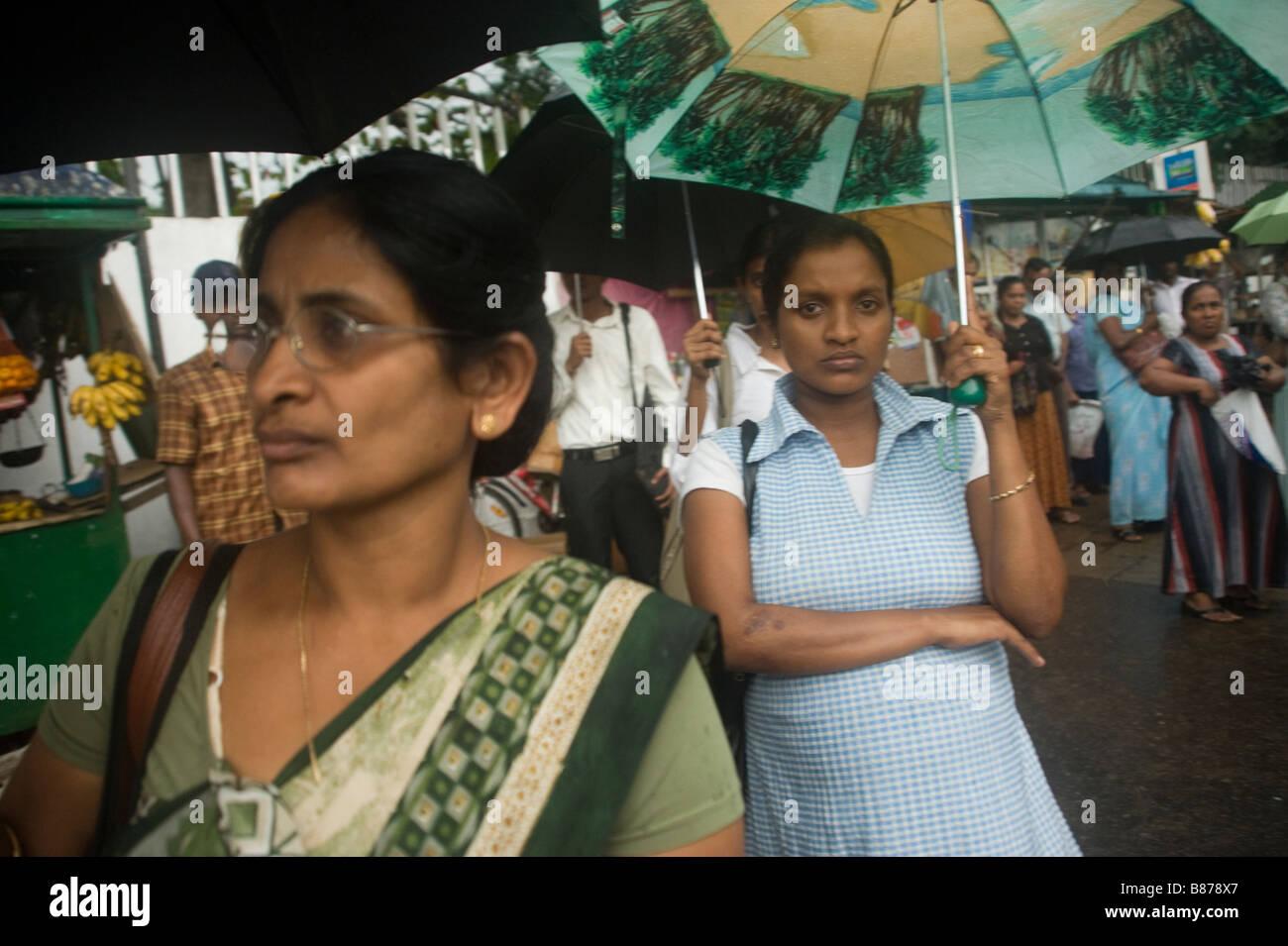 Woman with umbrellas in rain Colombo Sri Lanka 3697 Stock Photo - Alamy