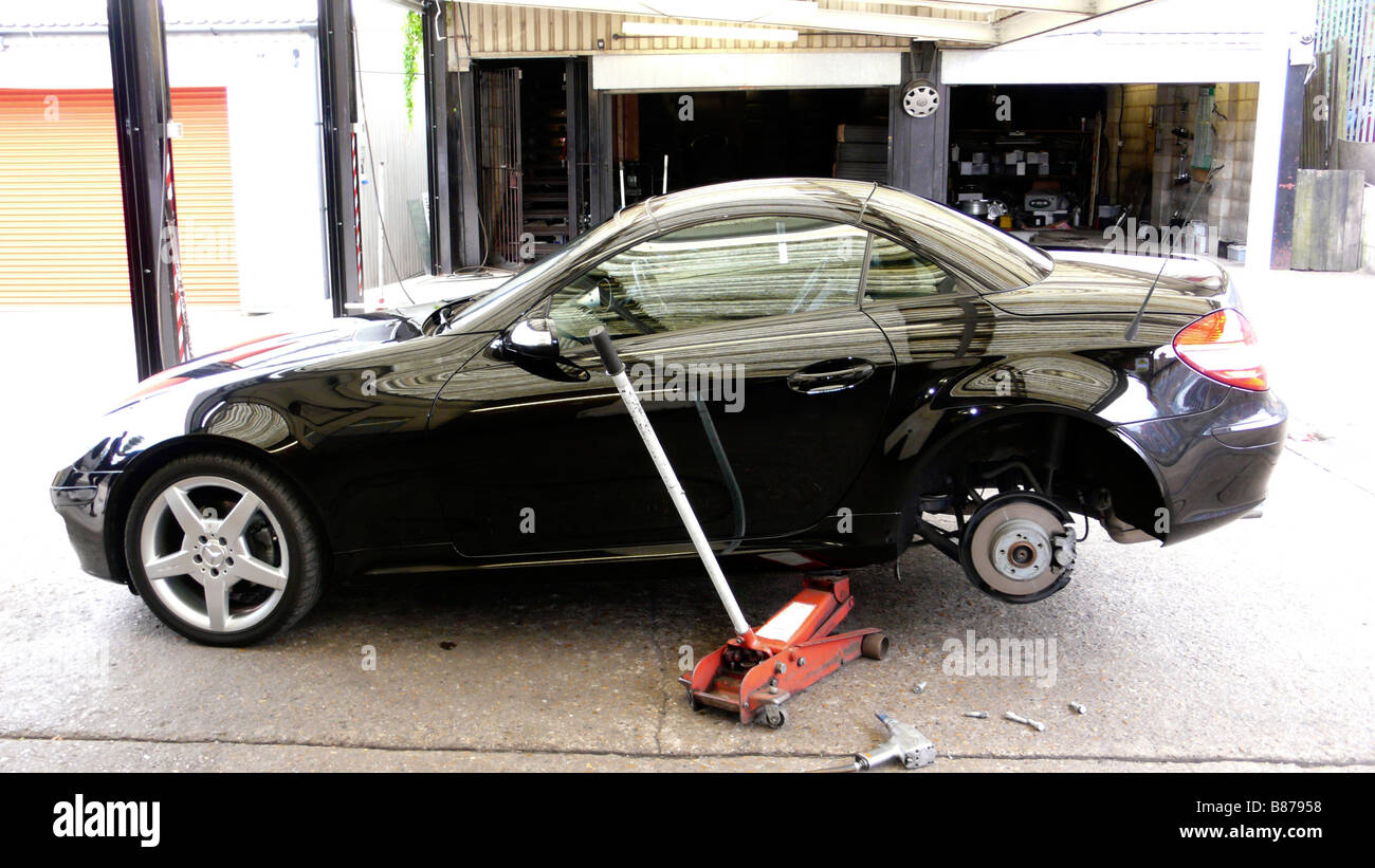 CAR ON JACK FOR WHEEL CHANGE Stock Photo - Alamy
