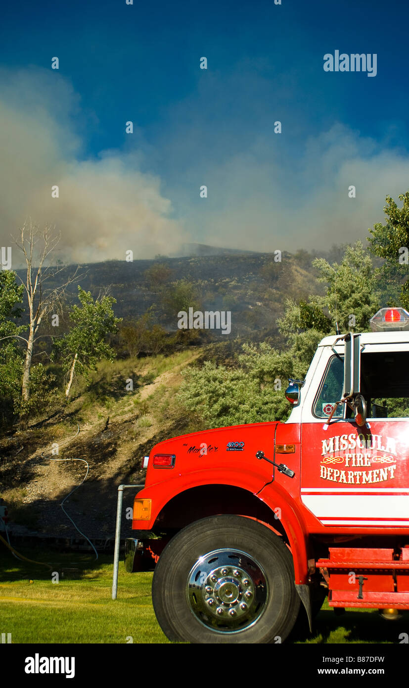 Wild fire raging on a mountain with a fire truck in the foreground ...