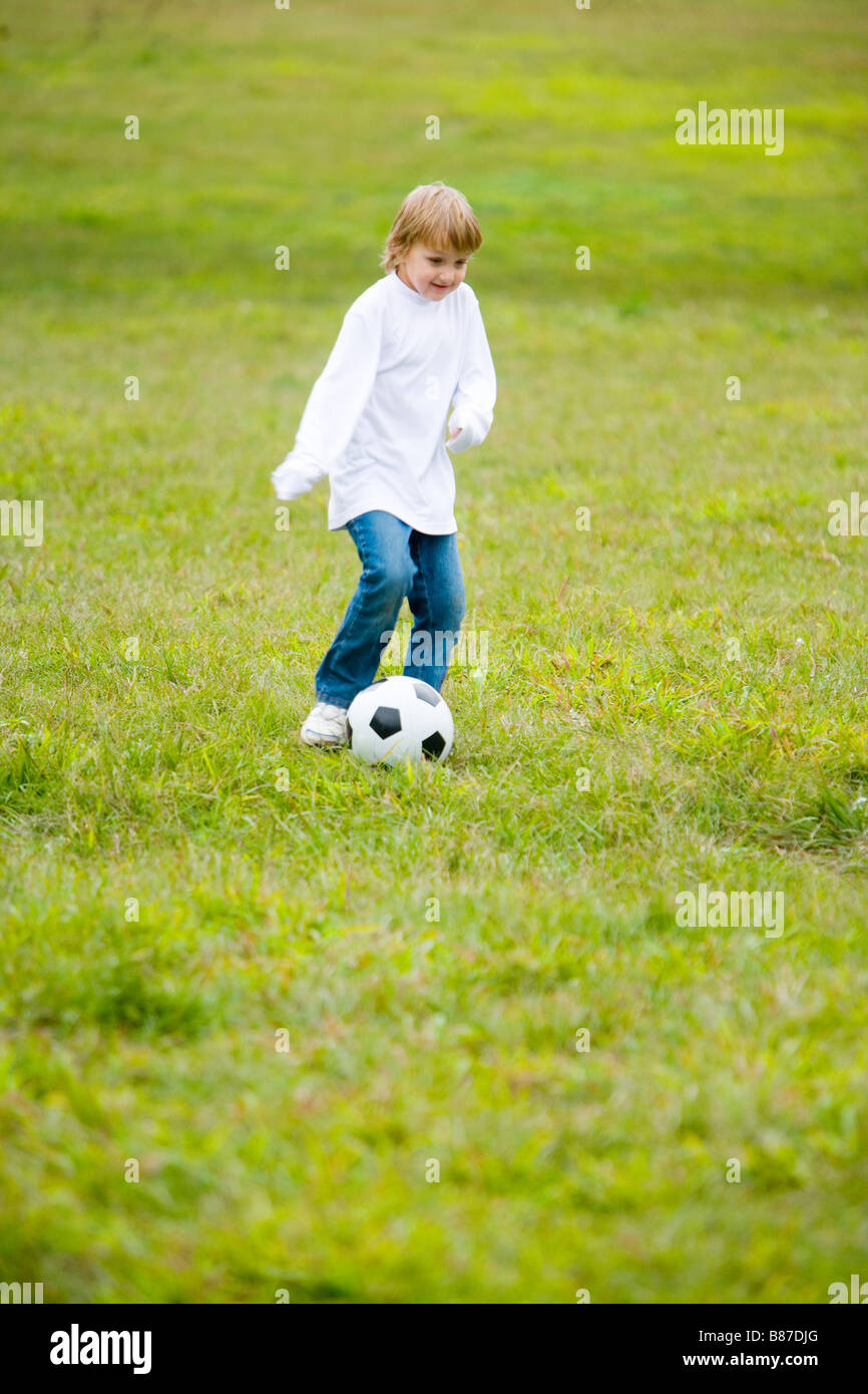 Boy playing soccer Stock Photo - Alamy