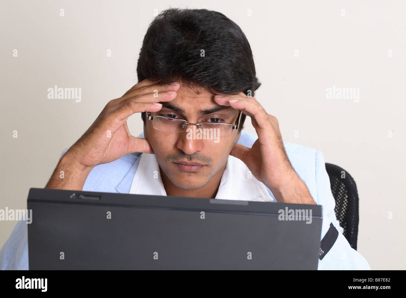 A man looking into his laptop Stock Photo - Alamy