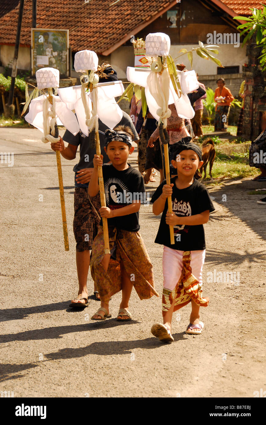Balinese boys holding effigies along cremation ceremony parade,Bali ...