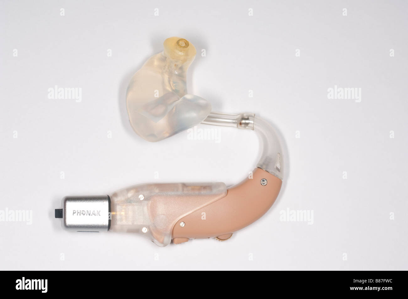 Childs hearing aid pictured with radio aid parts that connect directly ...