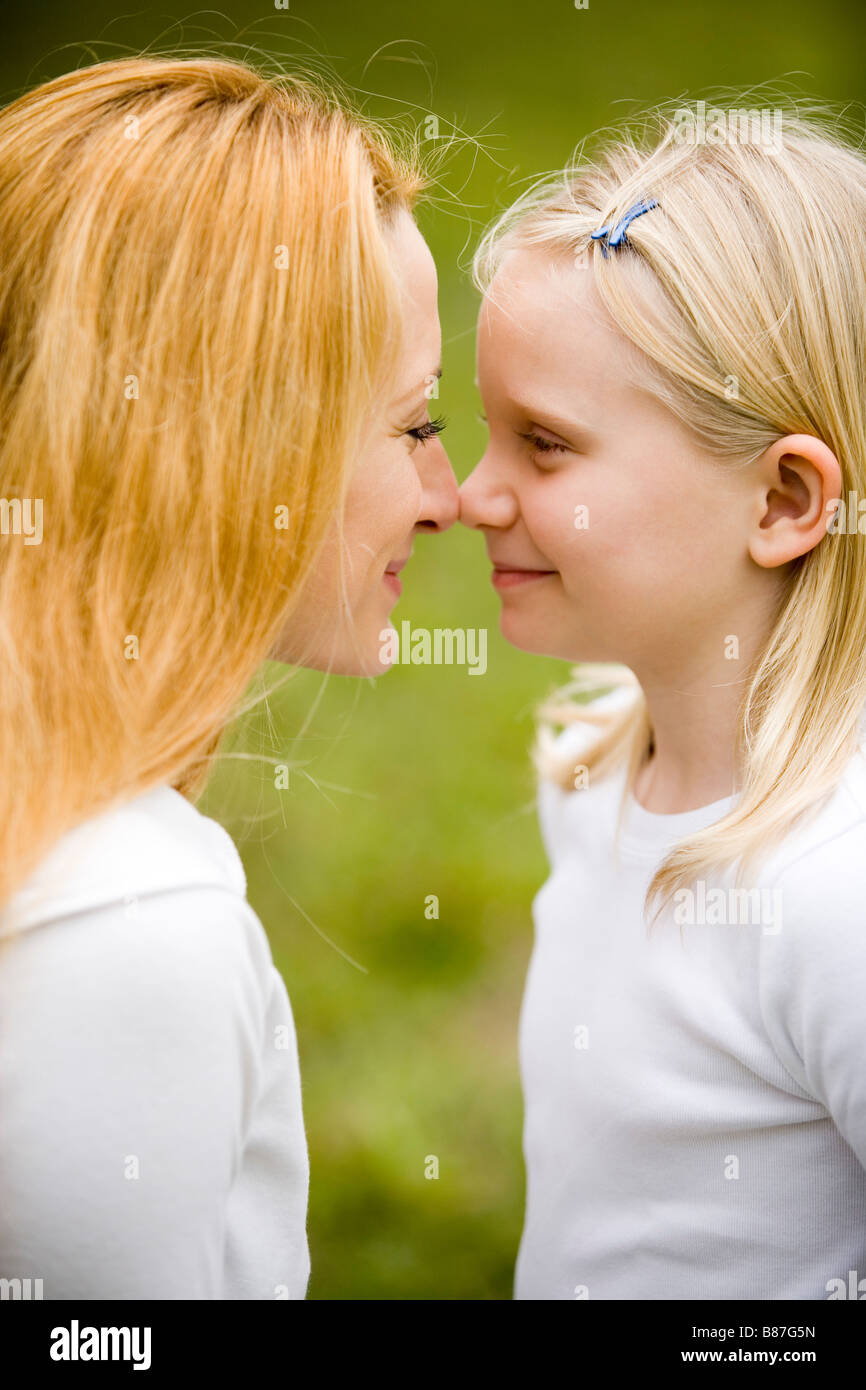 Mother and daughter touching noses side view Stock Photo - Alamy