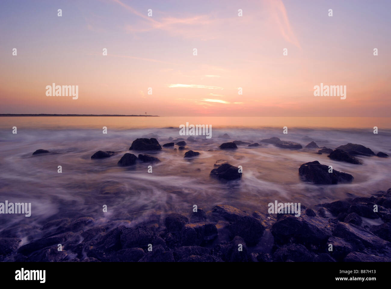 sunset and waves taken with a slow shutter speed Stock Photo - Alamy