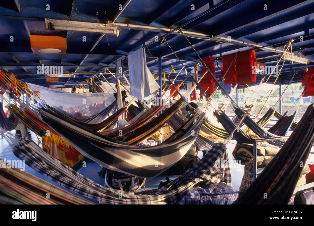 Travelers hammocks strung up on an ferry traveling down the Amazon ...