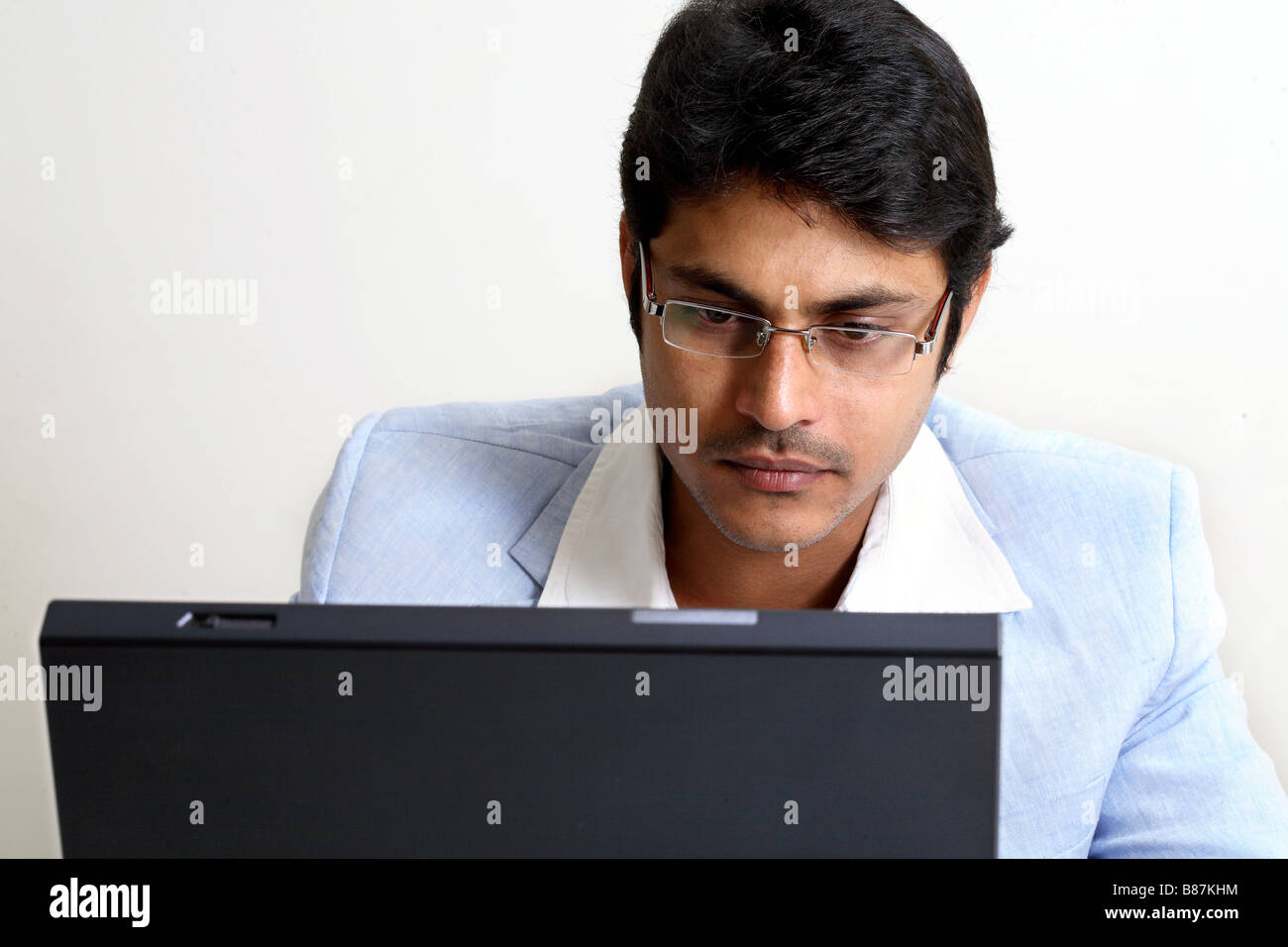 A man looking into his laptop Stock Photo - Alamy