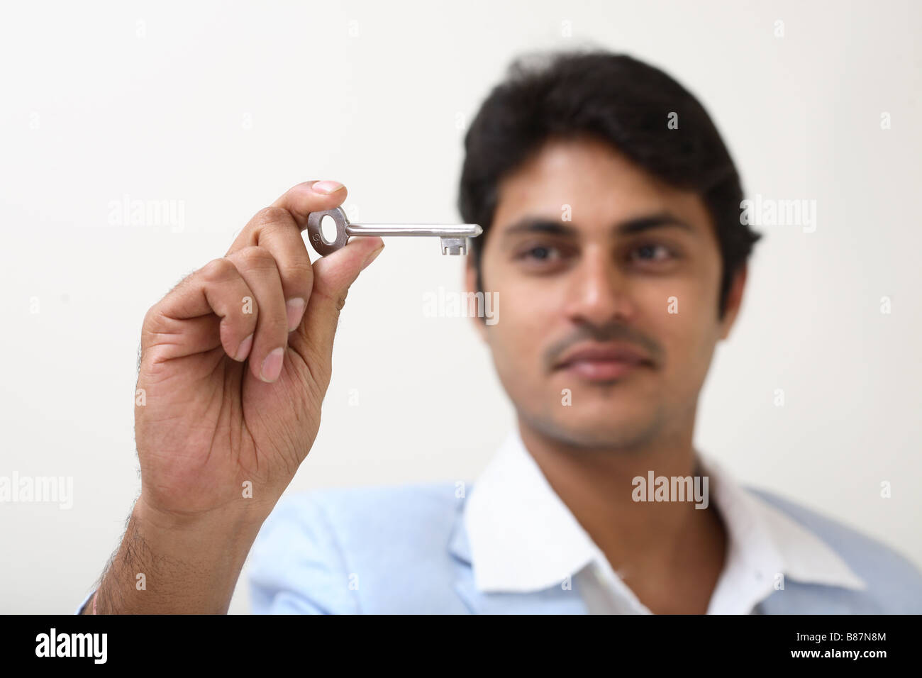 A man looking at a key Stock Photo - Alamy