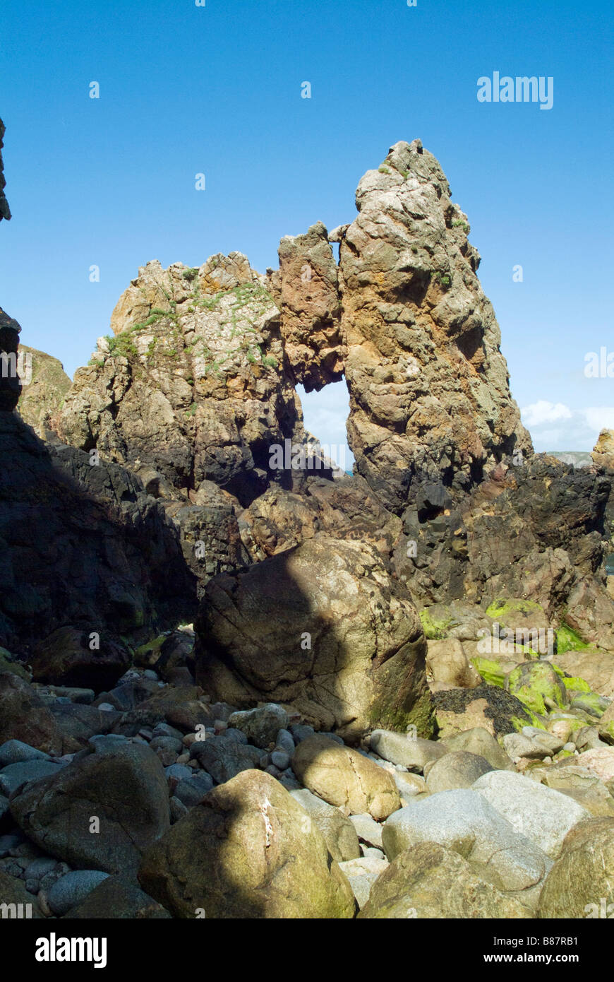 Stone archway off the coast of Sark Stock Photo - Alamy