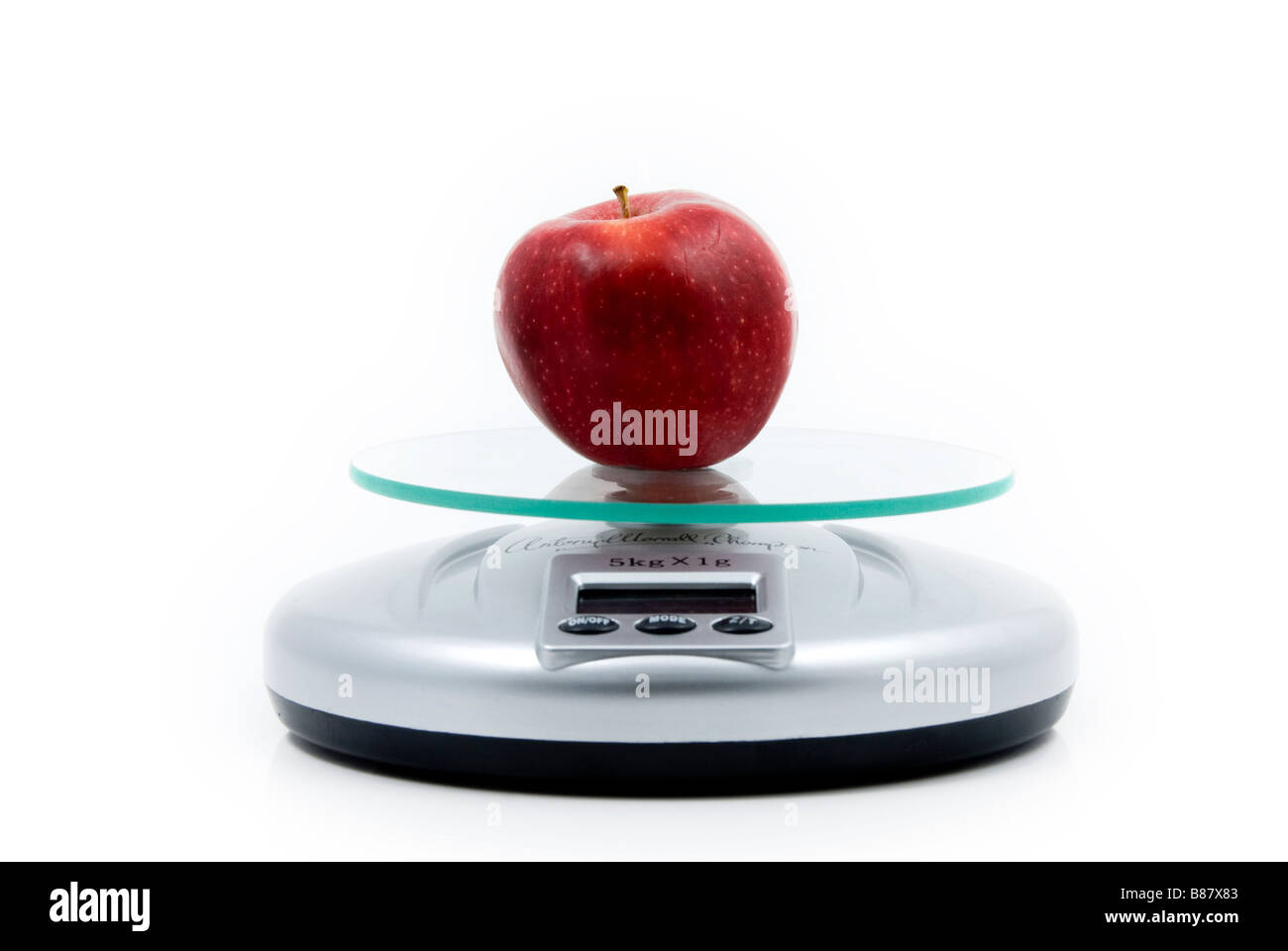 apple on a set of scales Stock Photo - Alamy