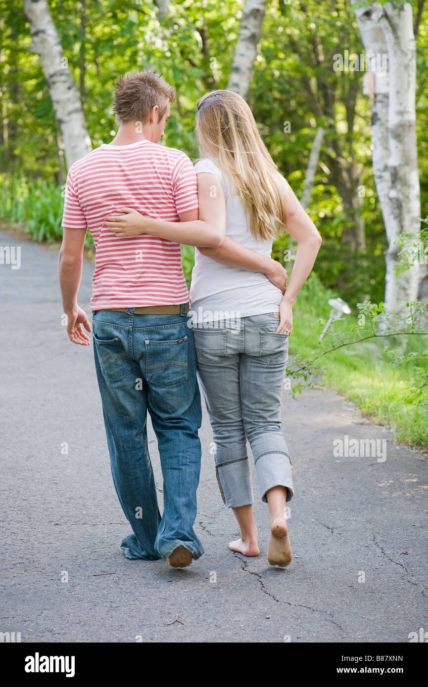 Young Couple Holding Hands Walking Away