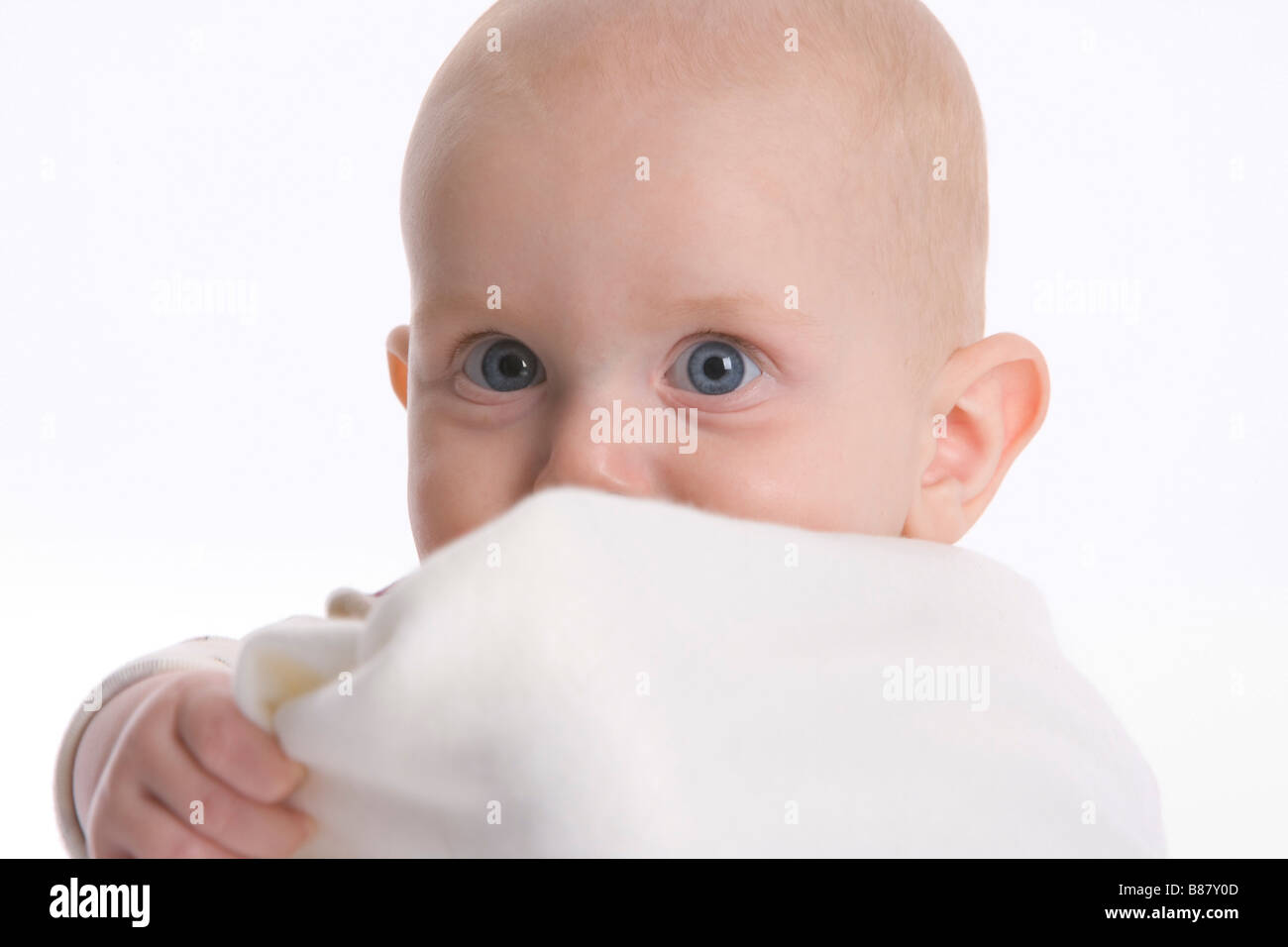Cute baby hiding behind a towel Stock Photo - Alamy