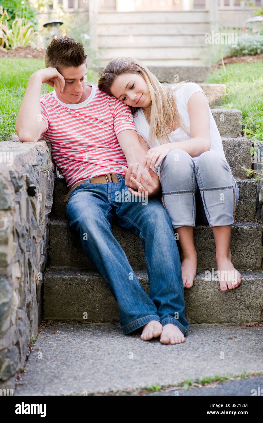 Young couple sitting outside together Stock Photo - Alamy