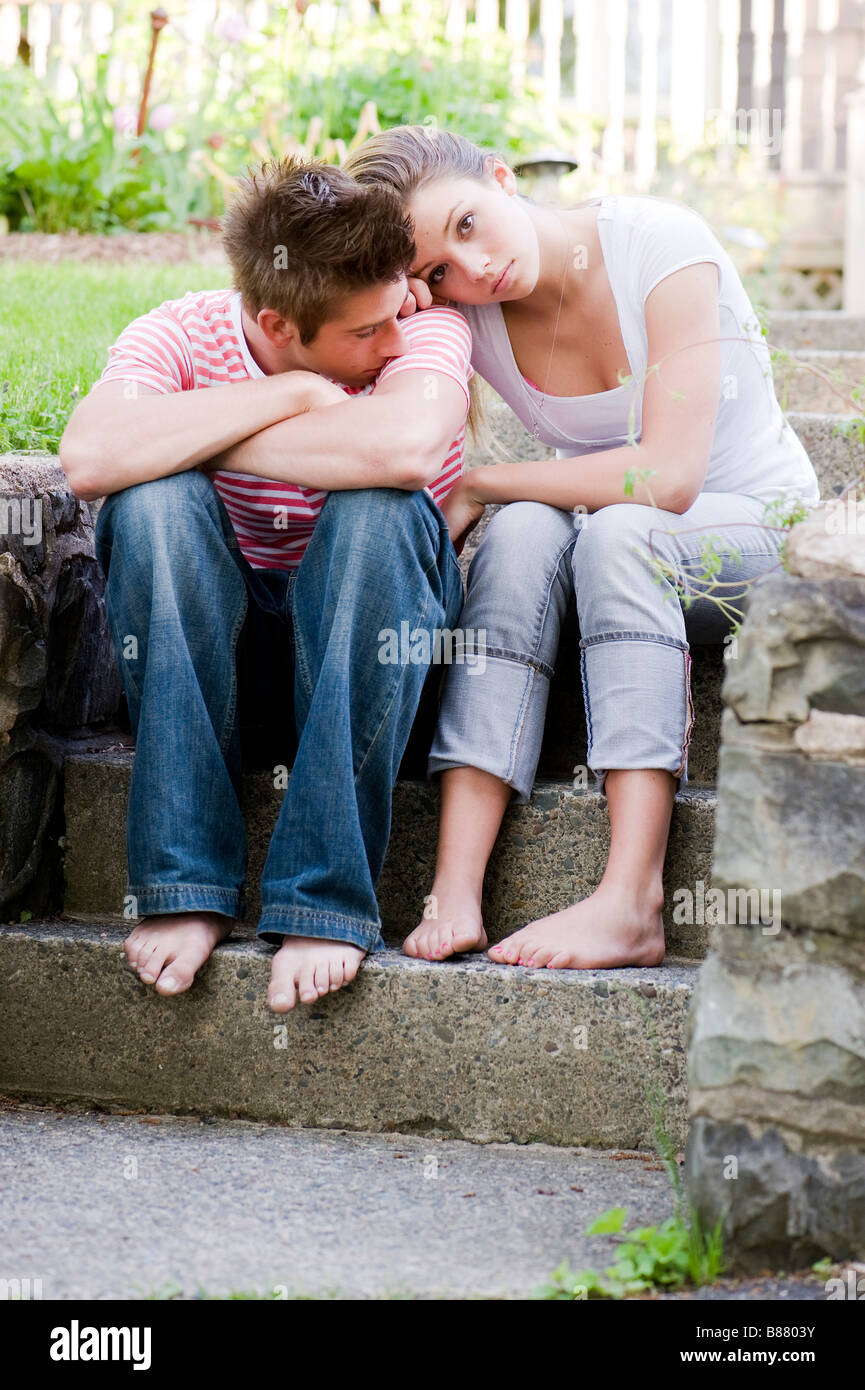 Two young lovers sit outside on the steps Stock Photo - Alamy