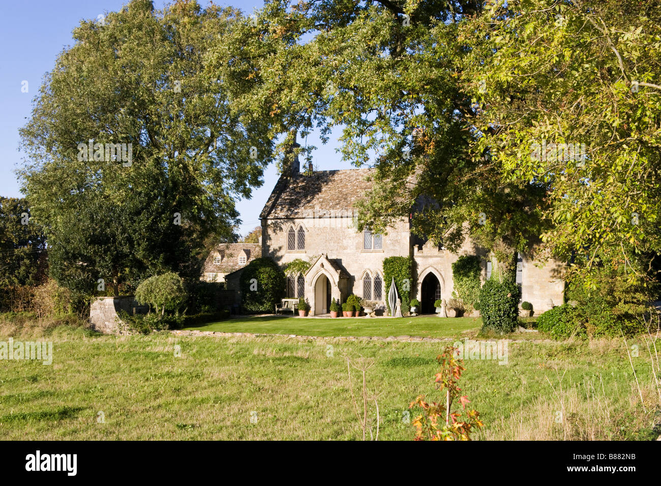 A house opposite the church in the Cotswold village of Cherington ...