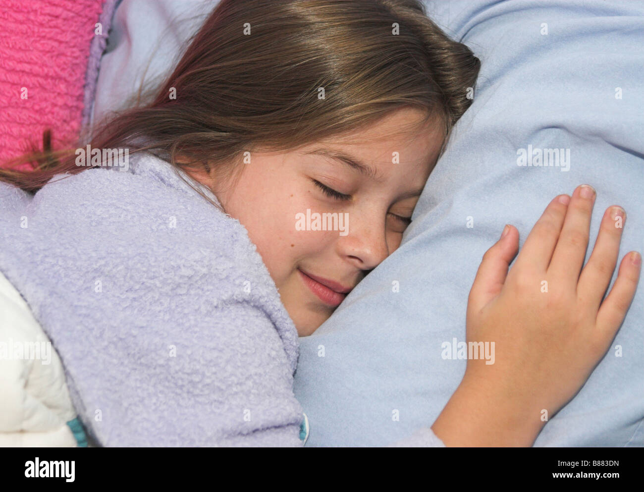 a pretty little girl sound asleep in bed Stock Photo - Alamy
