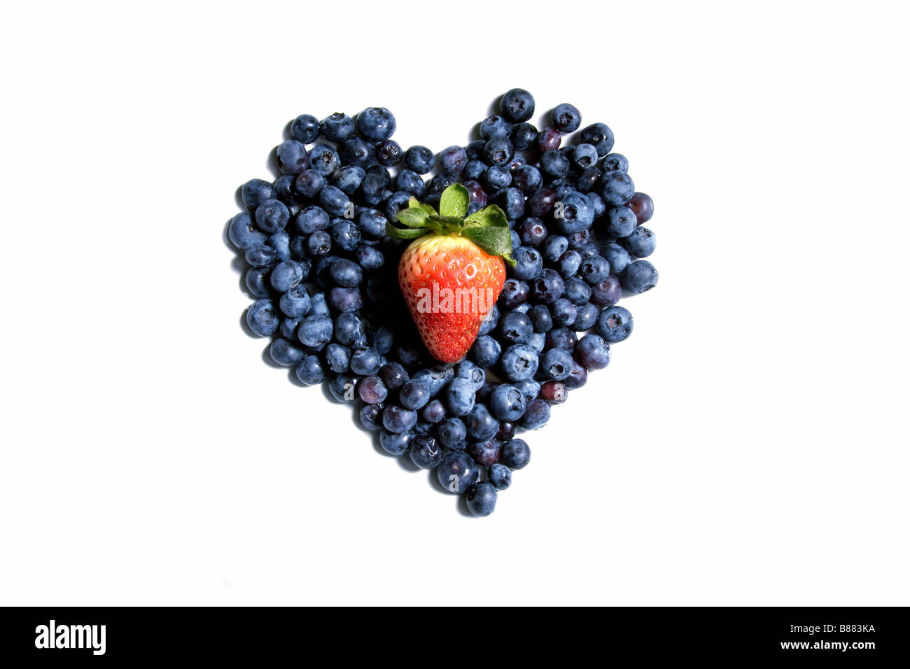 Blueberries and a strawberry shaped like a heart Stock Photo - Alamy