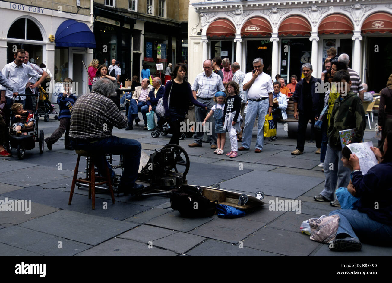 Busker performing to tourists in Abbey Churchyard Bath Spa Somerset UK ...