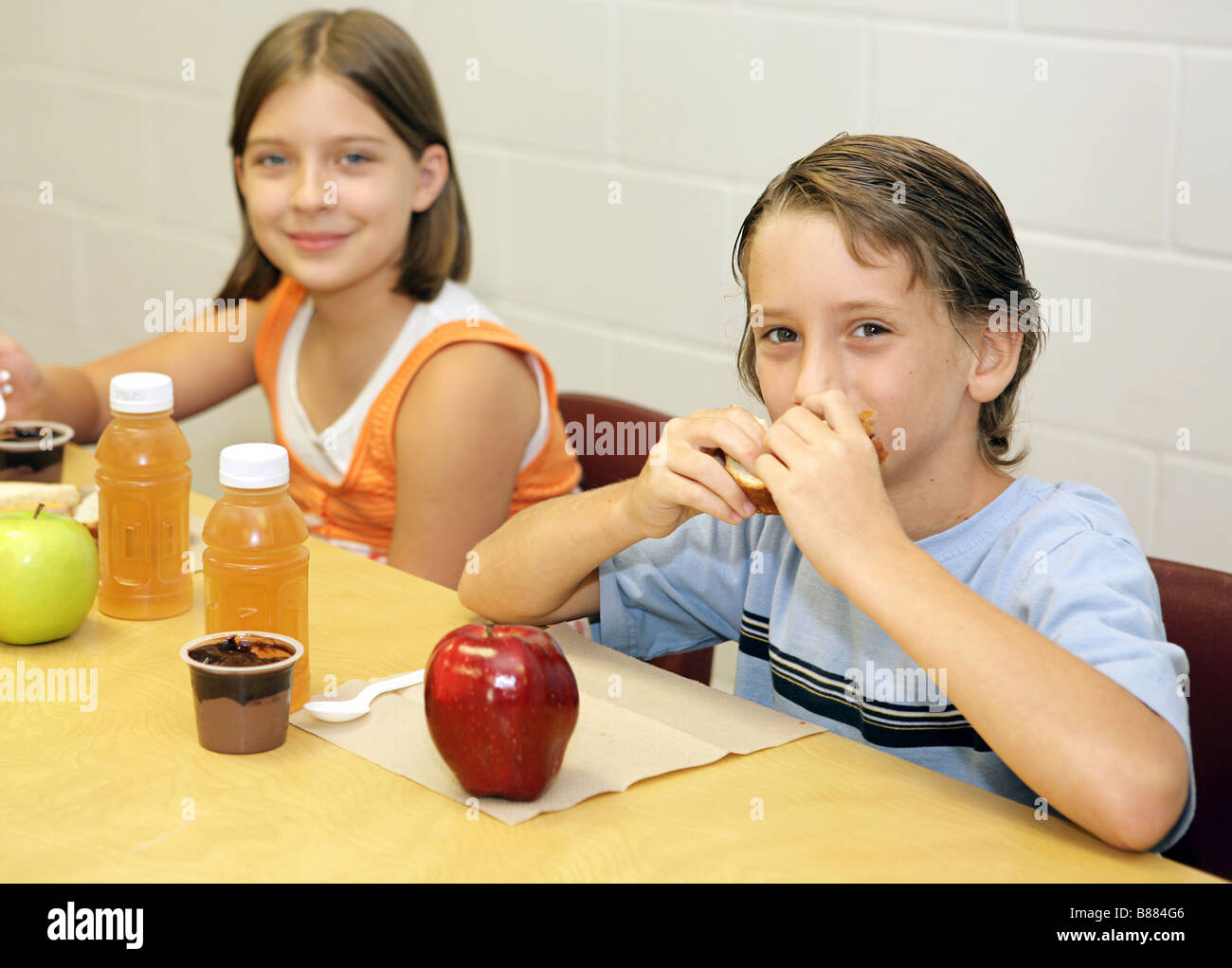A boy and girl eating a healthy lunch together in school Stock Photo ...