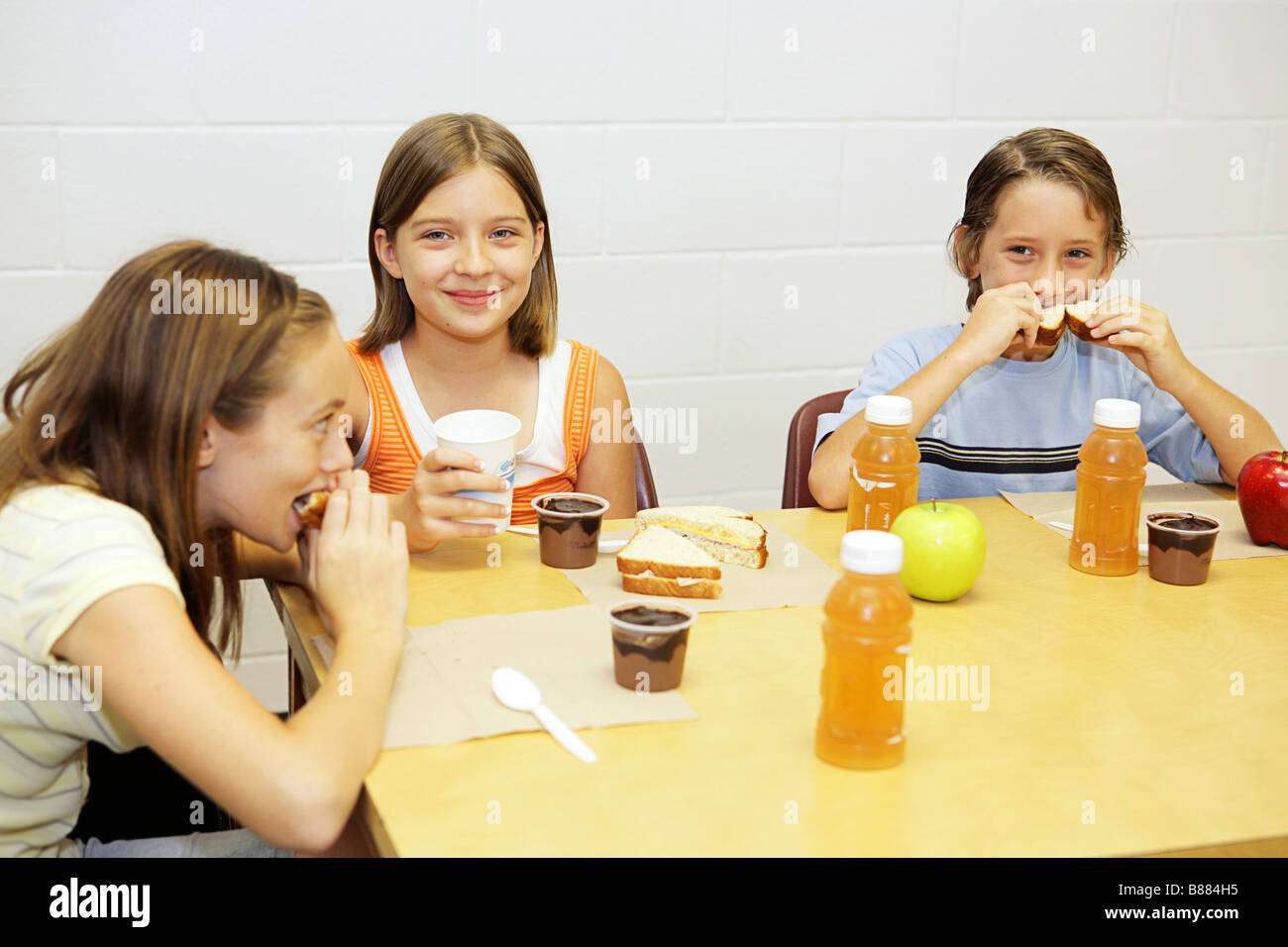 A group of school children having lunch in the school cafeteria Stock ...