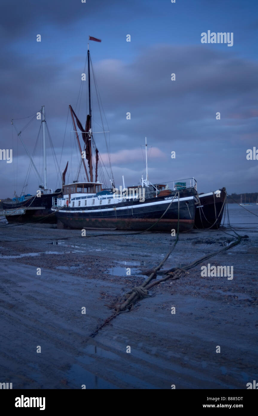 A sailing Thames barge on the mud at Pin Mill in Suffolk as twilight ...