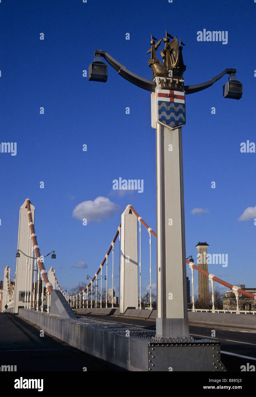 Chelsea Bridge with statue of golden ship and crest on lamp London ...