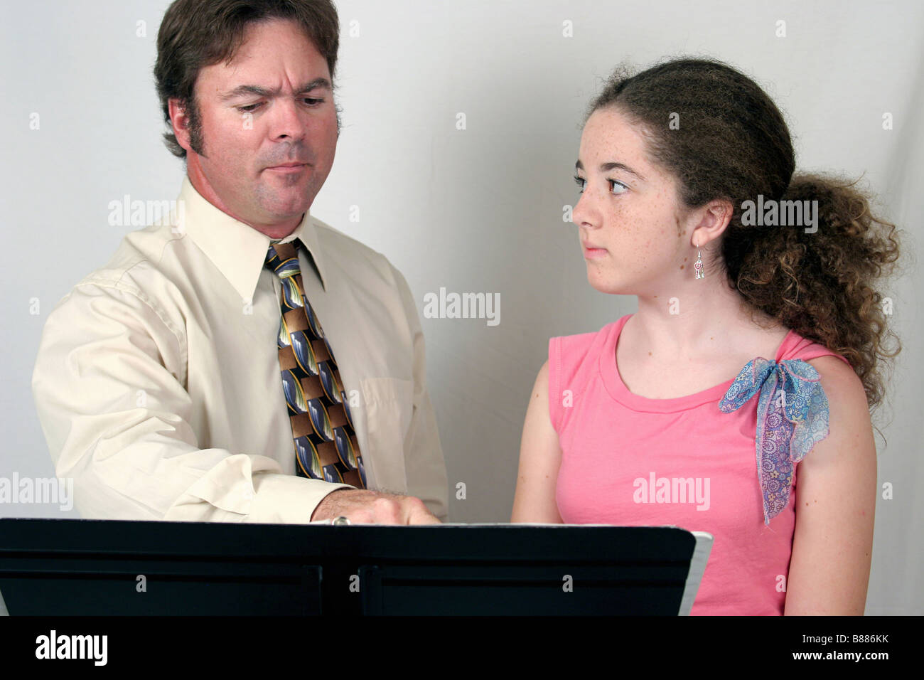 Front view of a voice teacher teaching a student to sing Stock Photo ...