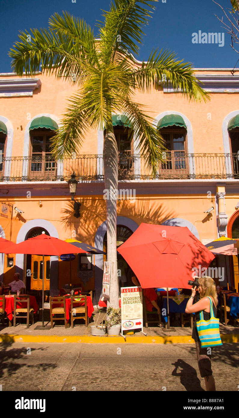 MEXICO SINOLA STATE MAZATLAN Woman tourist taking a picture of pastel ...