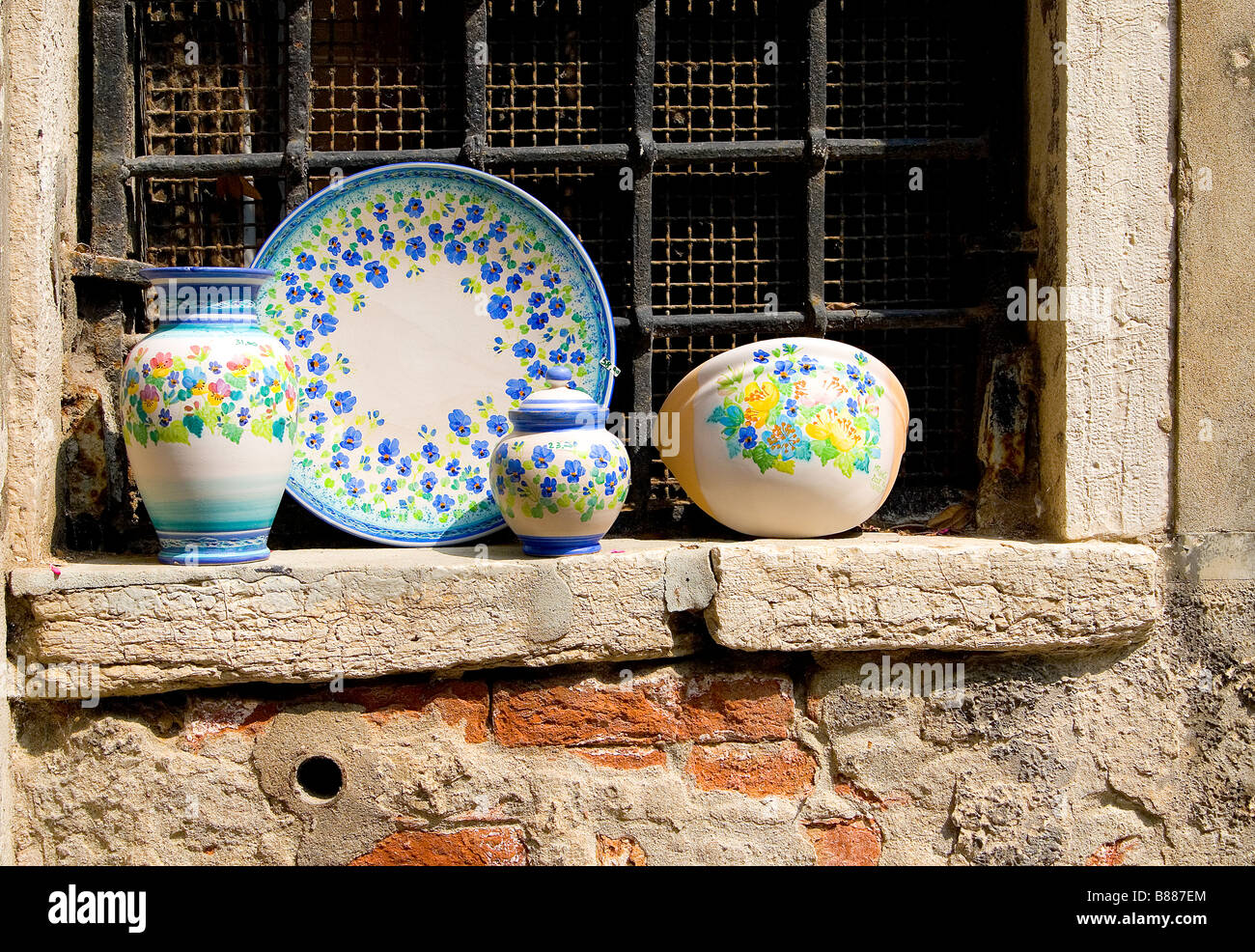 Handmade pottery on a window ledge in Italy Stock Photo - Alamy