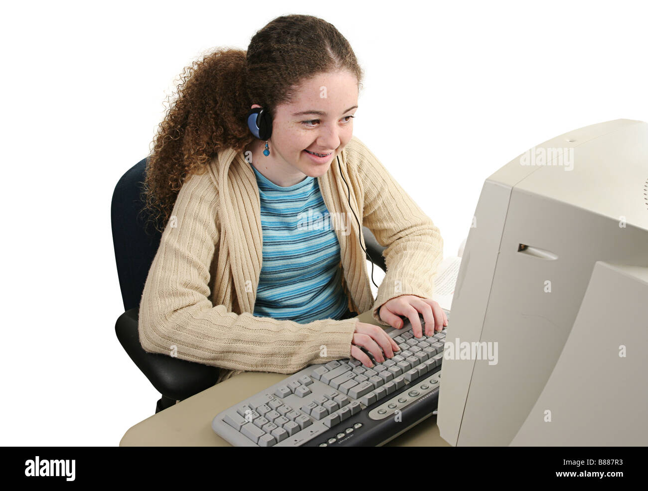 A teen girl smiling as she surfs the internet Stock Photo - Alamy