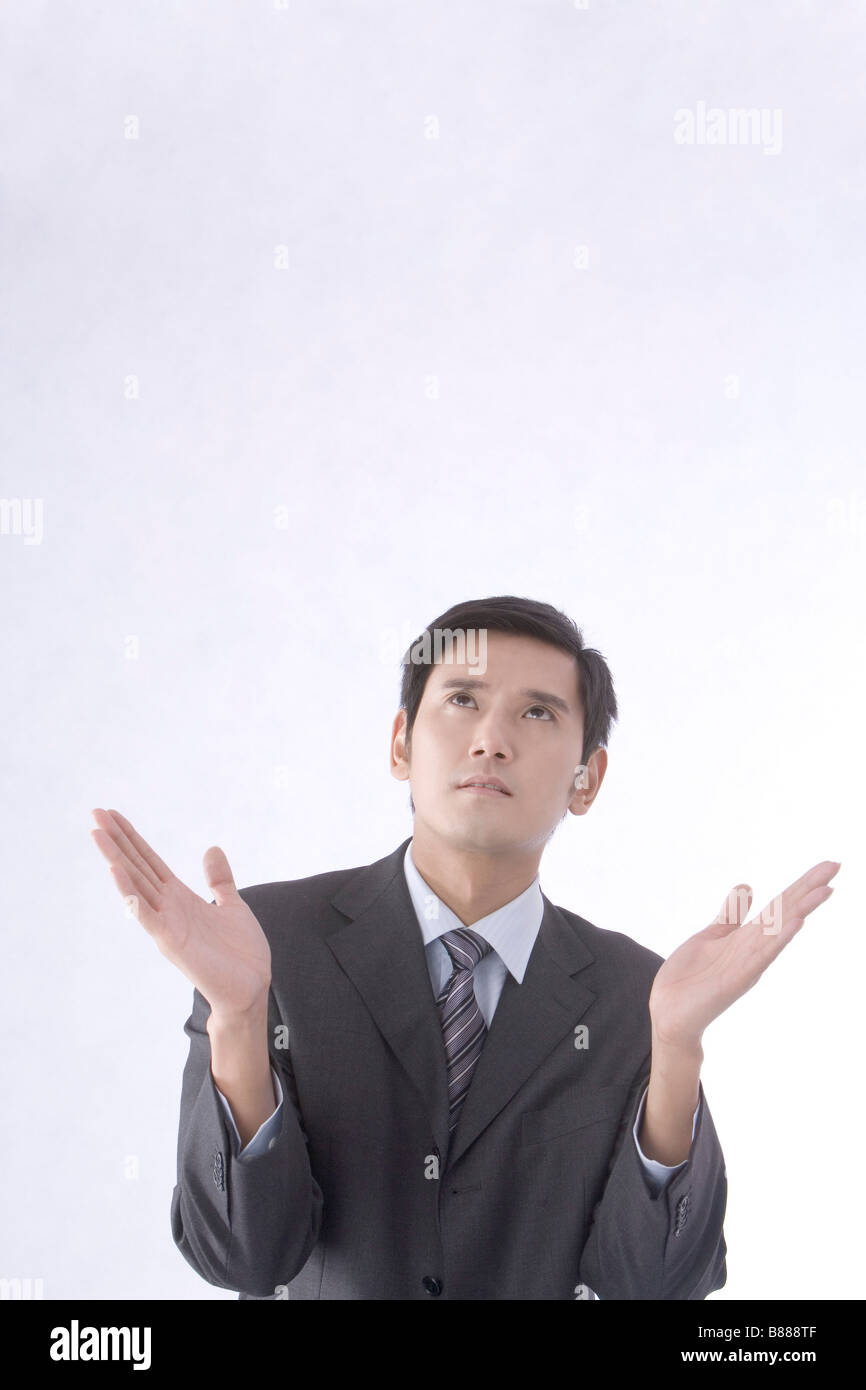 Young businessman hands out looking up portrait Stock Photo - Alamy