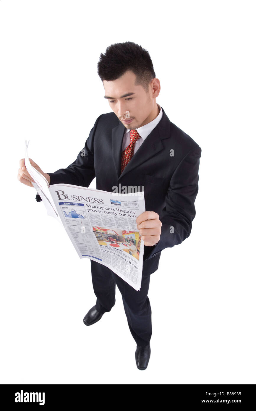 Young businessman reading newspaper Stock Photo - Alamy Young businessman reading newspaper Stock Photo - Alamy