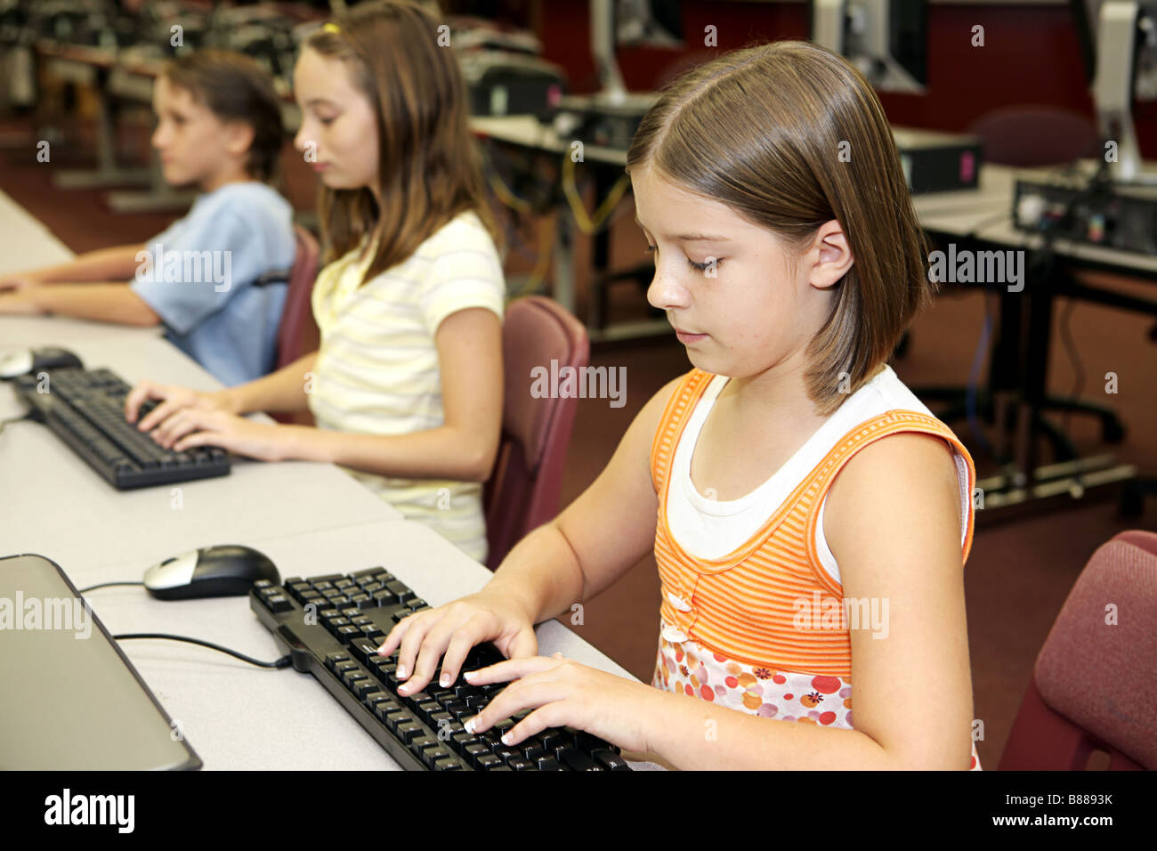 School children learning computers in the library media center Stock ...