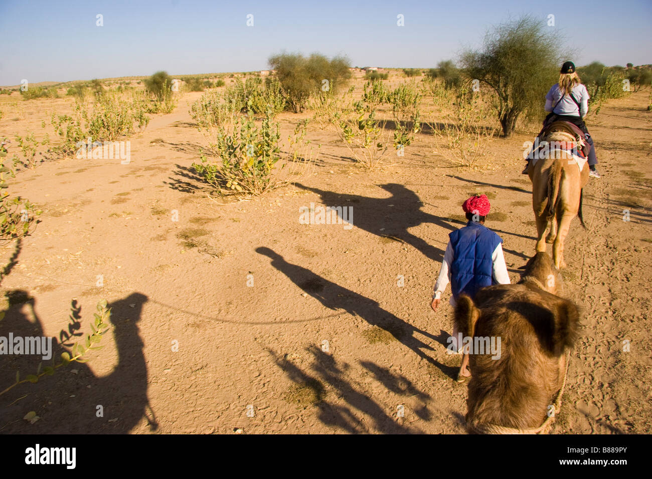 Tourist rides camel in desert Khuri Rajasthan India Stock Photo - Alamy