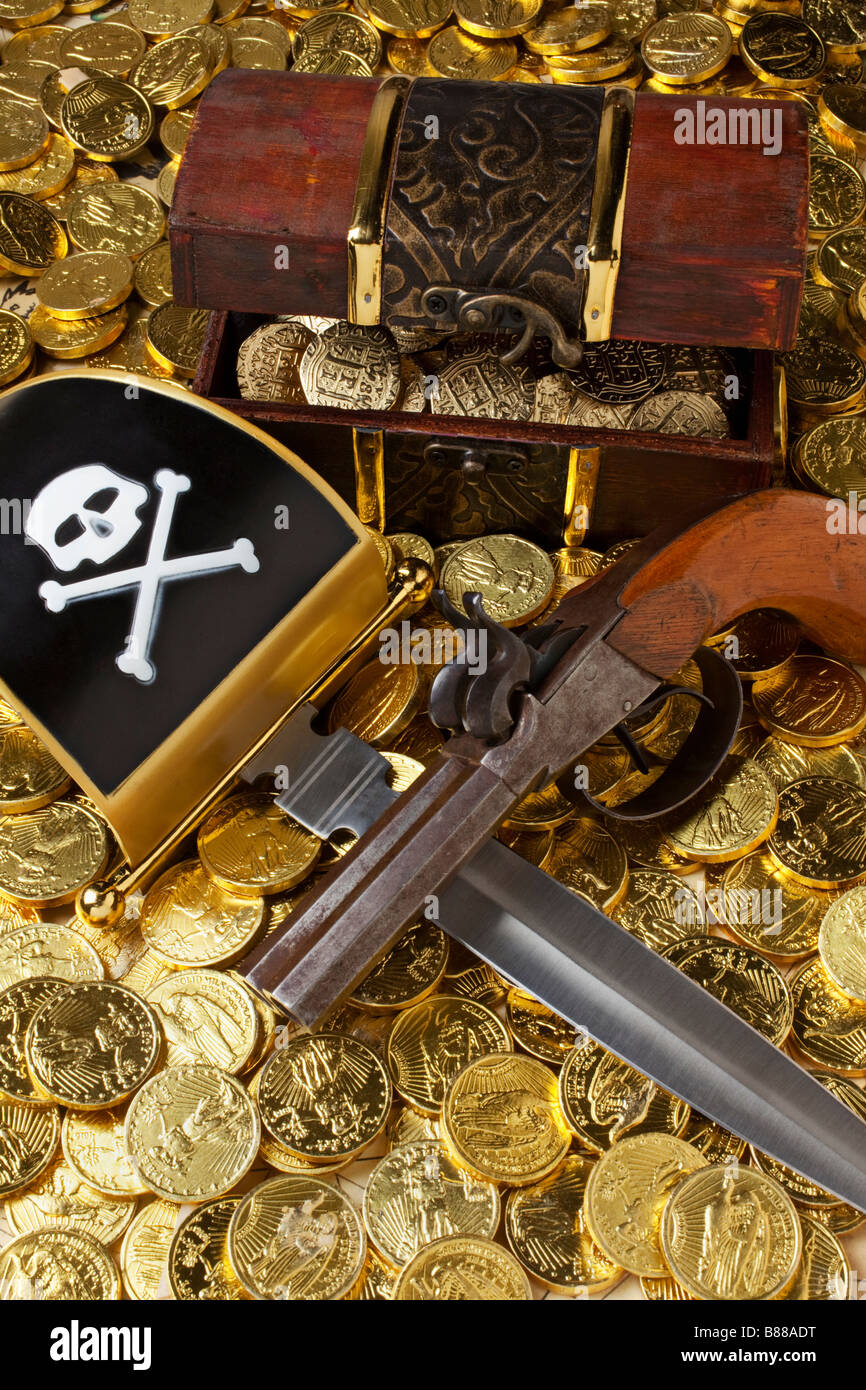Treasure chest with gold coins sword and gun Stock Photo - Alamy
