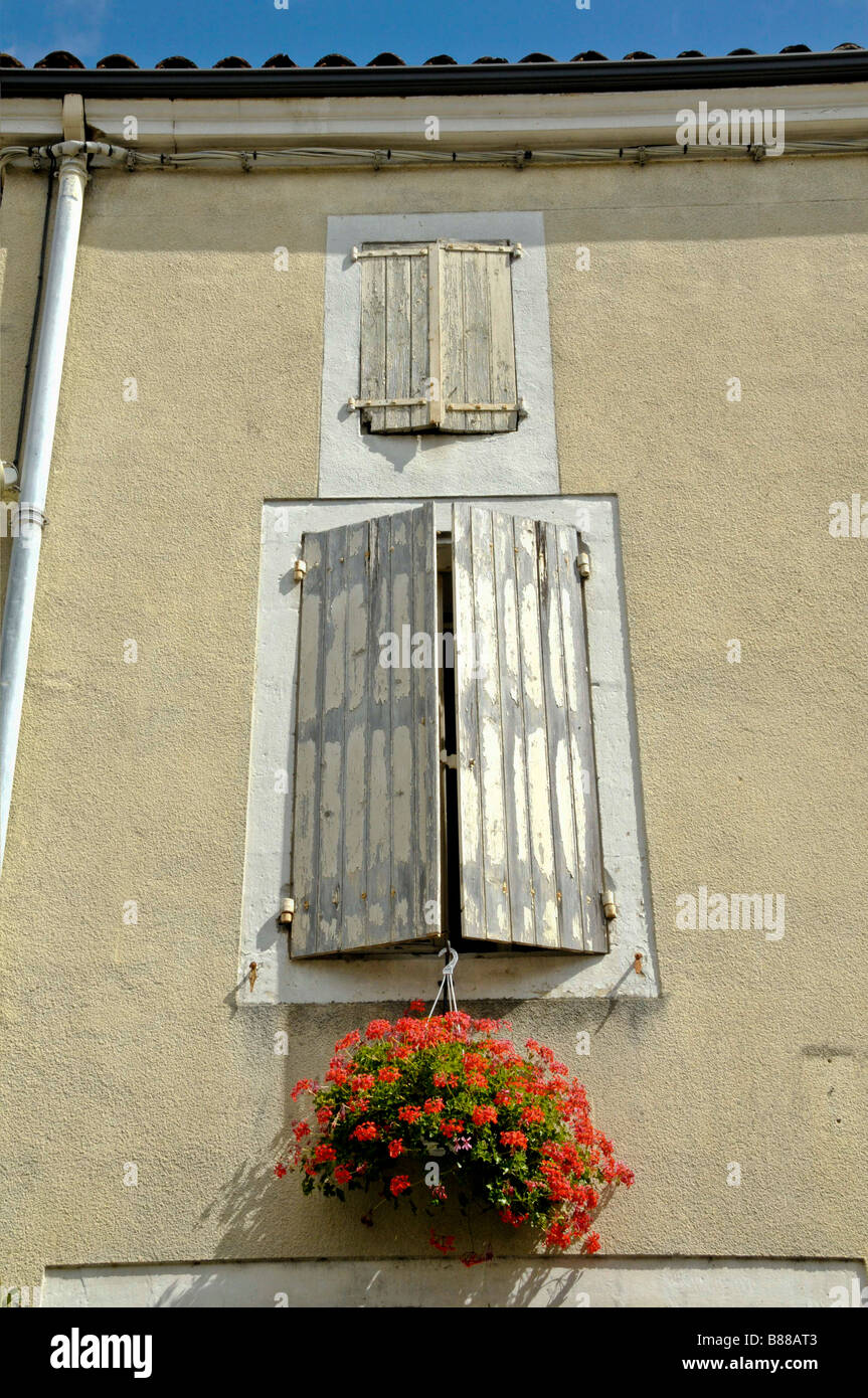 A shuttered window in a town square in the Dordogne region of France ...
