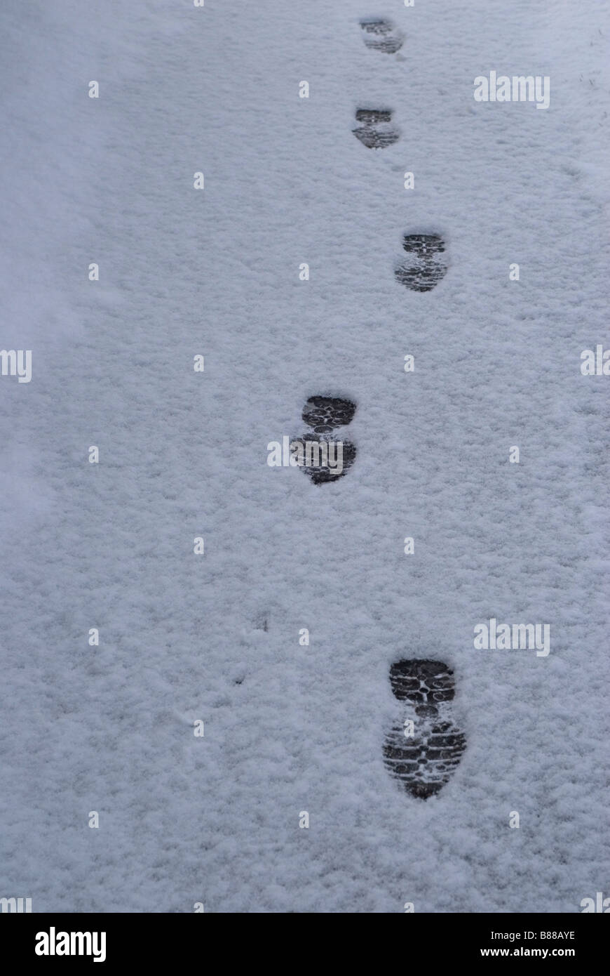 Footsteps in the snow Stock Photo - Alamy