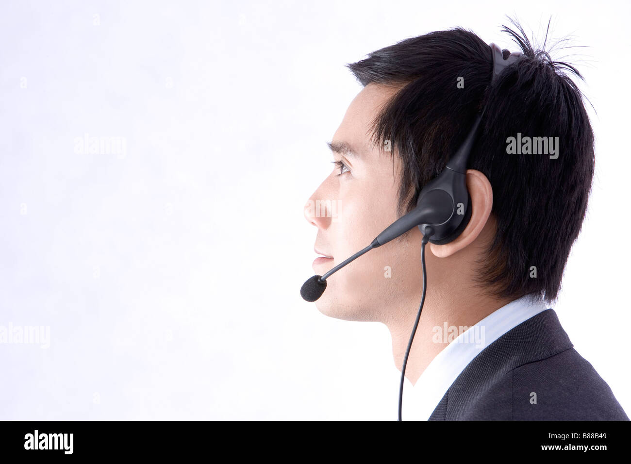 Young businessman with headset side view Stock Photo - Alamy