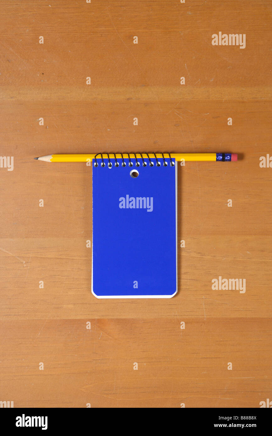 A note pad and pencil on a desk in an office Stock Photo - Alamy