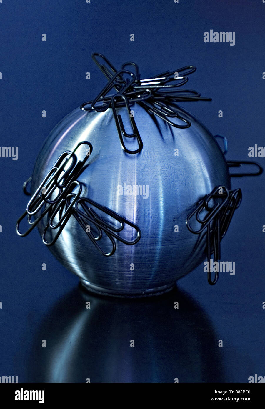 Magnetic iron ball with paper clips attached to it Stock Photo - Alamy