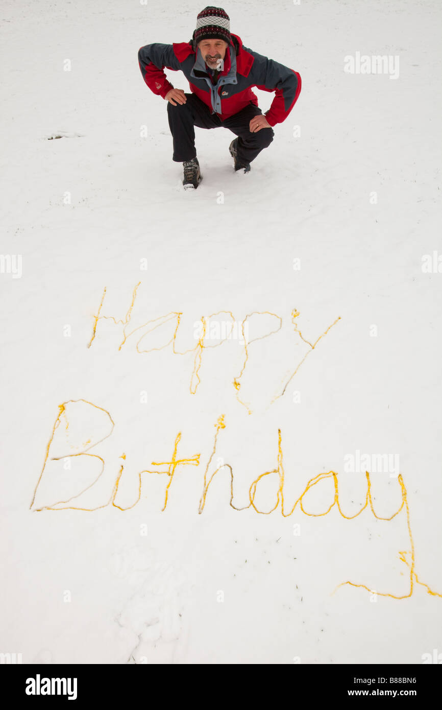 Happy Birthday written in the snow by a man weeing Stock Photo - Alamy