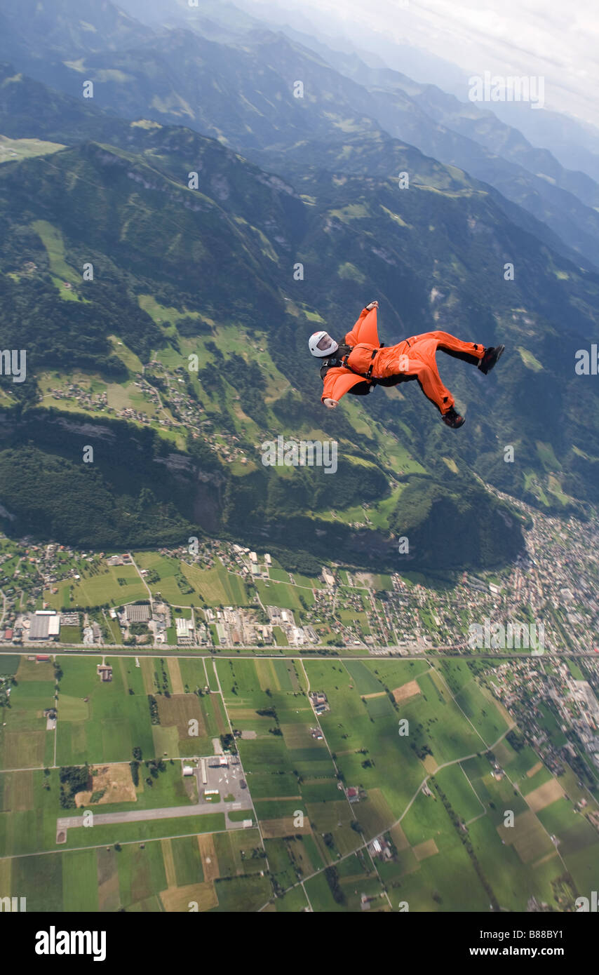 Orange skydiver is freefalling with helmet hi-res stock photography and ...