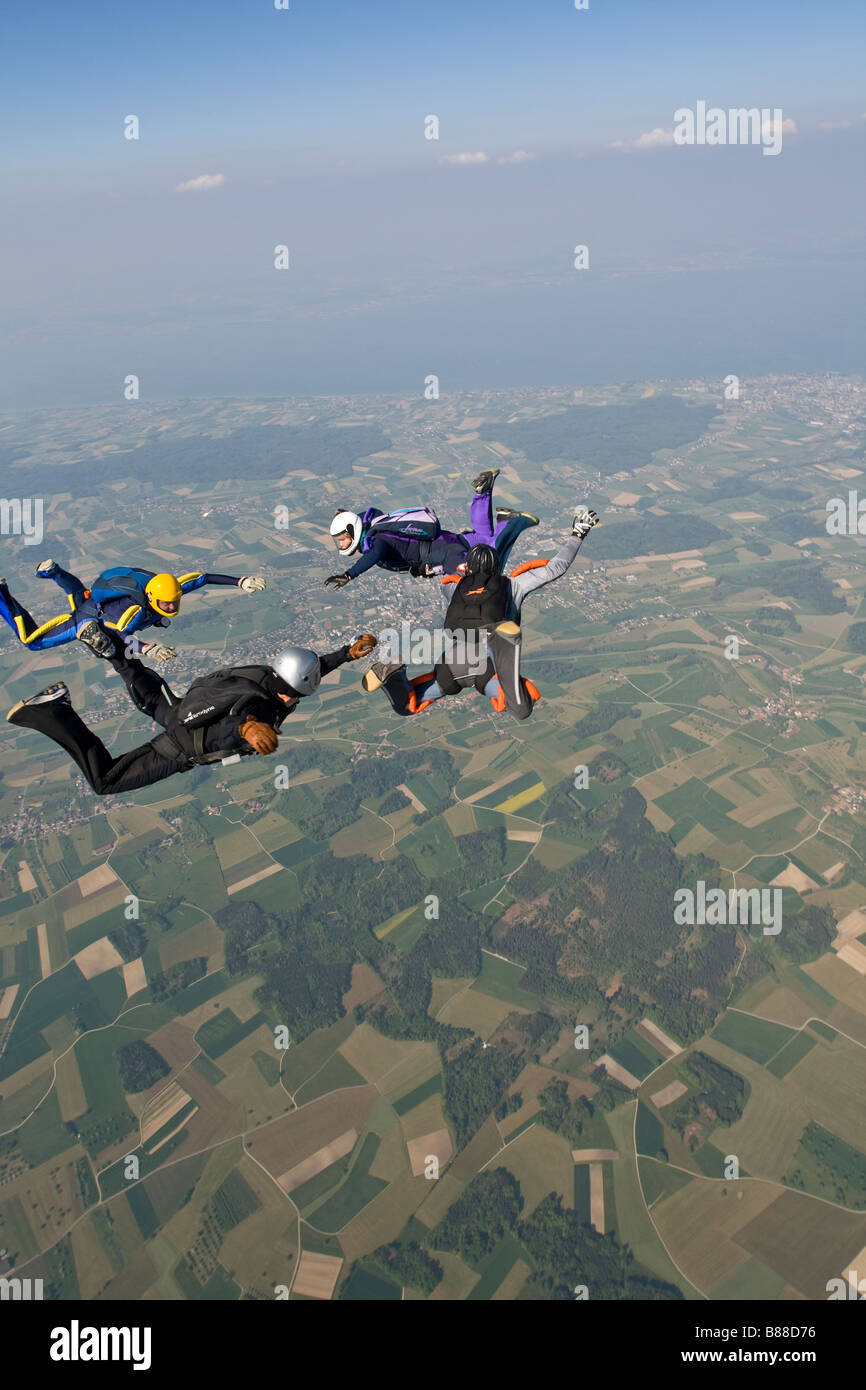 Skydiver team is flying a formation in the sky over a spectacularly ...