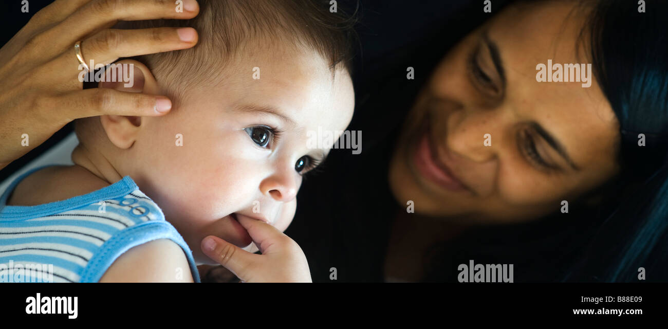 Baby mother cuddling baby arms hi-res stock photography and images - Alamy