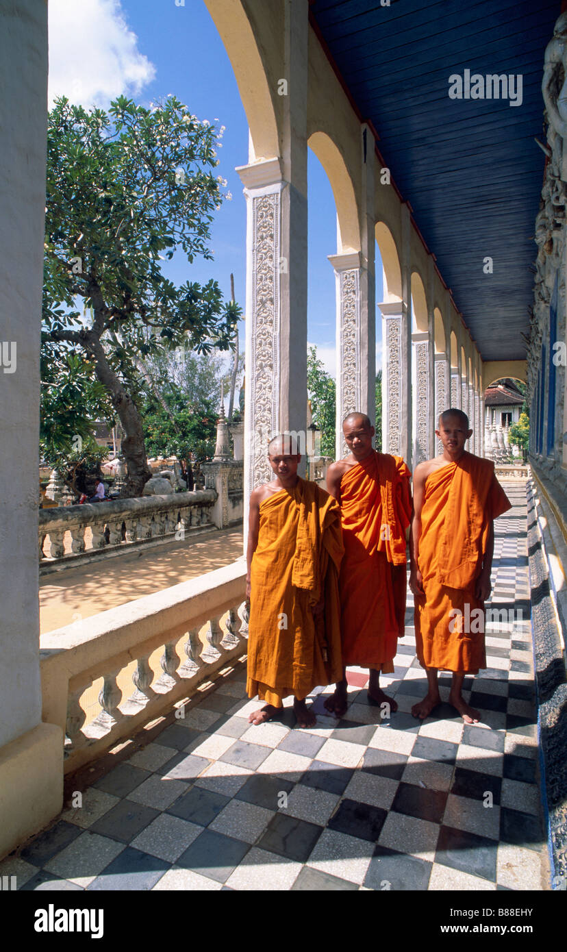 Wat Bo temple Cloisters Three Buddhist monks in saffron orange robes ...