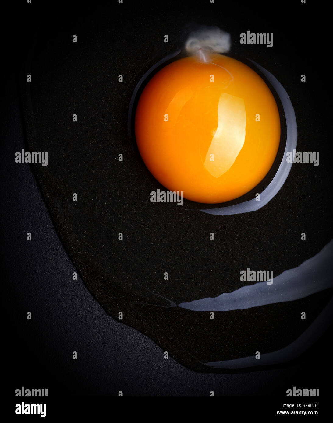 fine image of orange egg in a black pan Stock Photo - Alamy