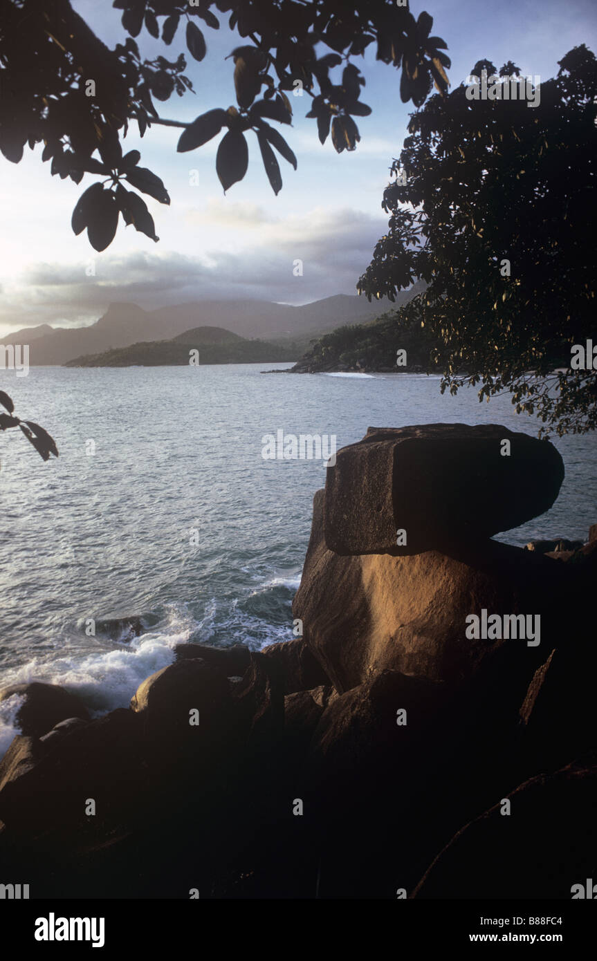 Seychelles islands view of translucent sea, green palms dramatic sunlit ...