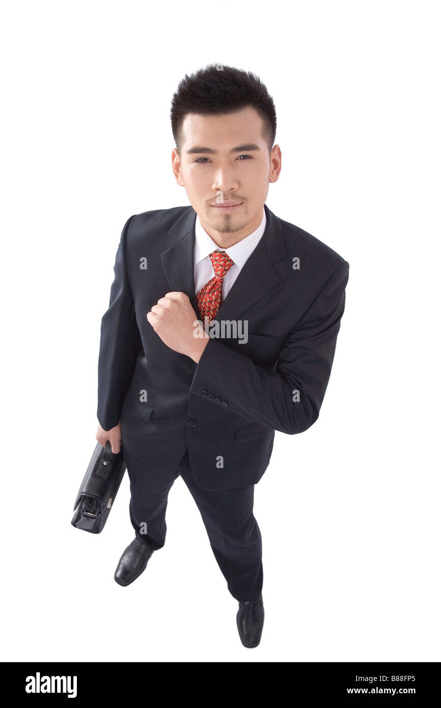 Young businessman holding briefcase portrait Stock Photo - Alamy